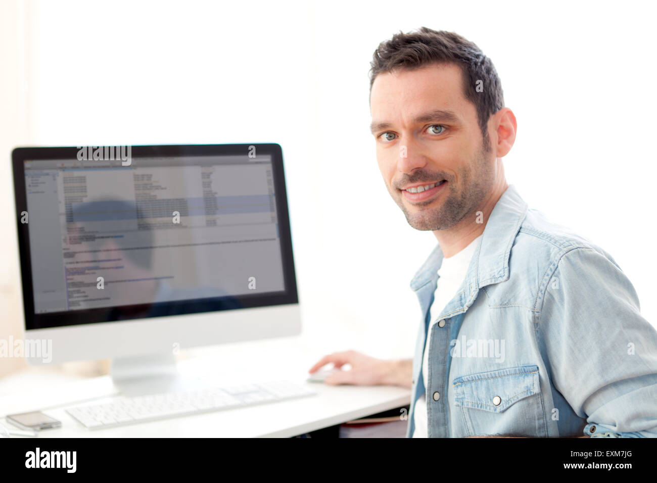 View of a young relaxed man using computer Stock Photo - Alamy