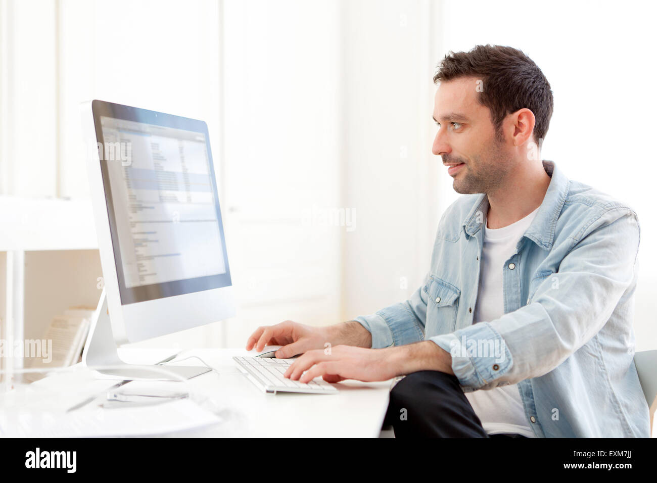 View of a young relaxed man using computer Stock Photo - Alamy