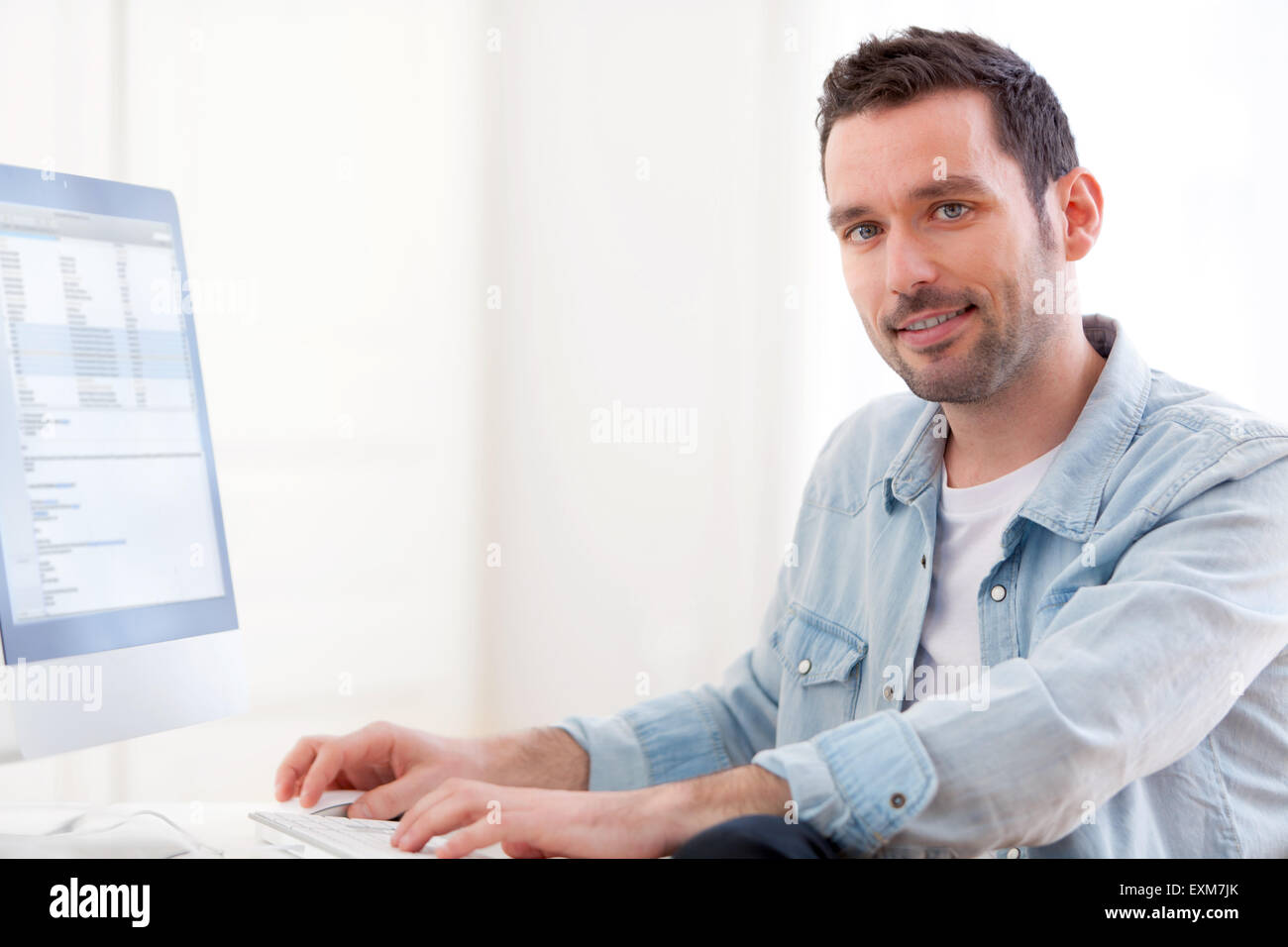 View of a young relaxed man using computer Stock Photo - Alamy