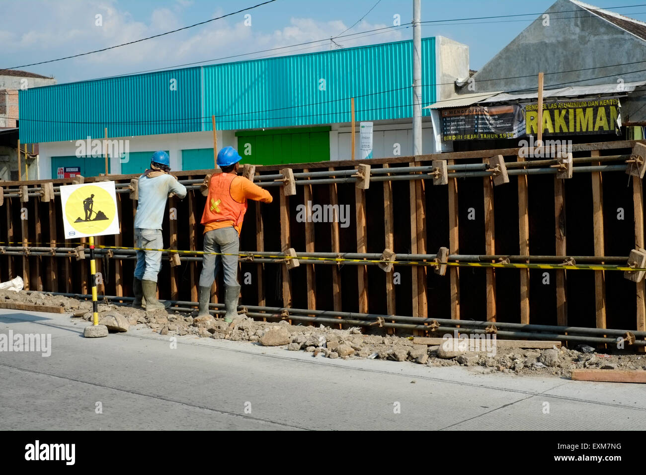 local workmen busy building a new flyover on a busy stretch of road in ...
