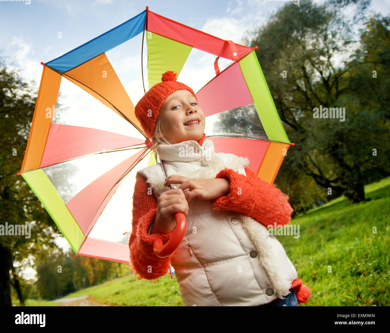 Beautiful little girl with colorful umbrella Stock Photo - Alamy