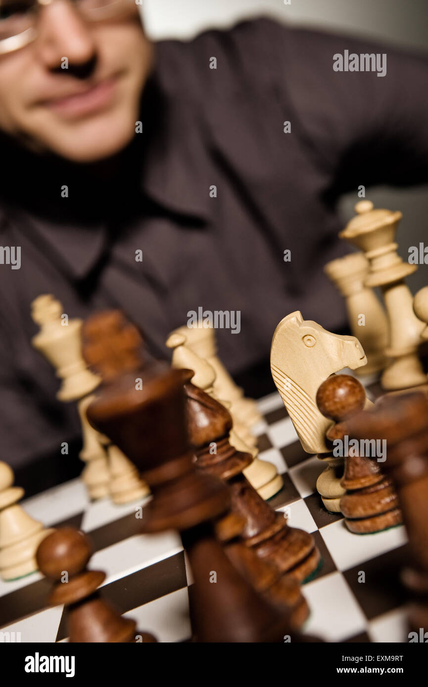 Chess master thinking before making a move (shallow Dof, focus on chess ...