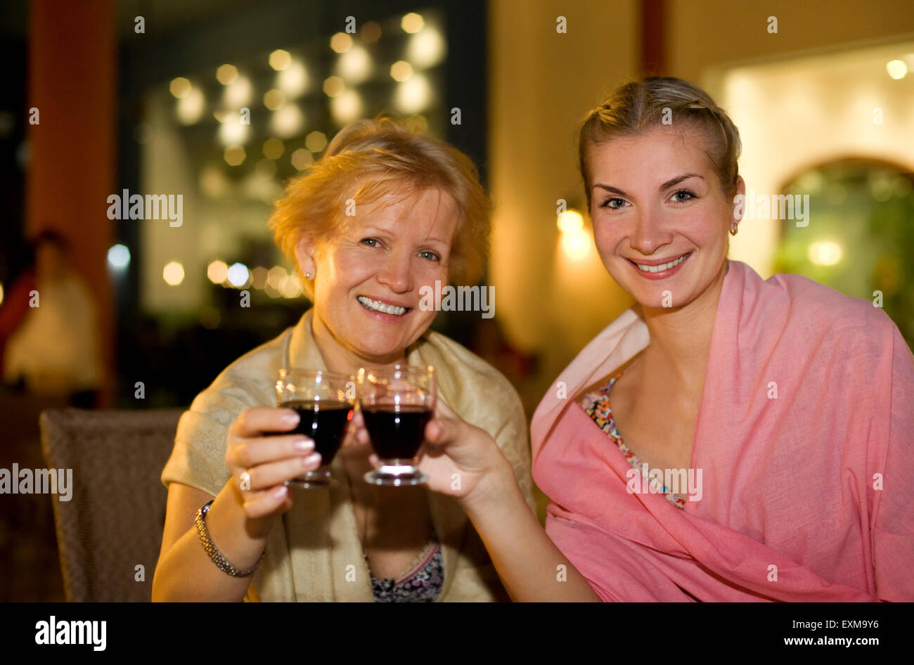Two beautiful women celebrating Stock Photo - Alamy