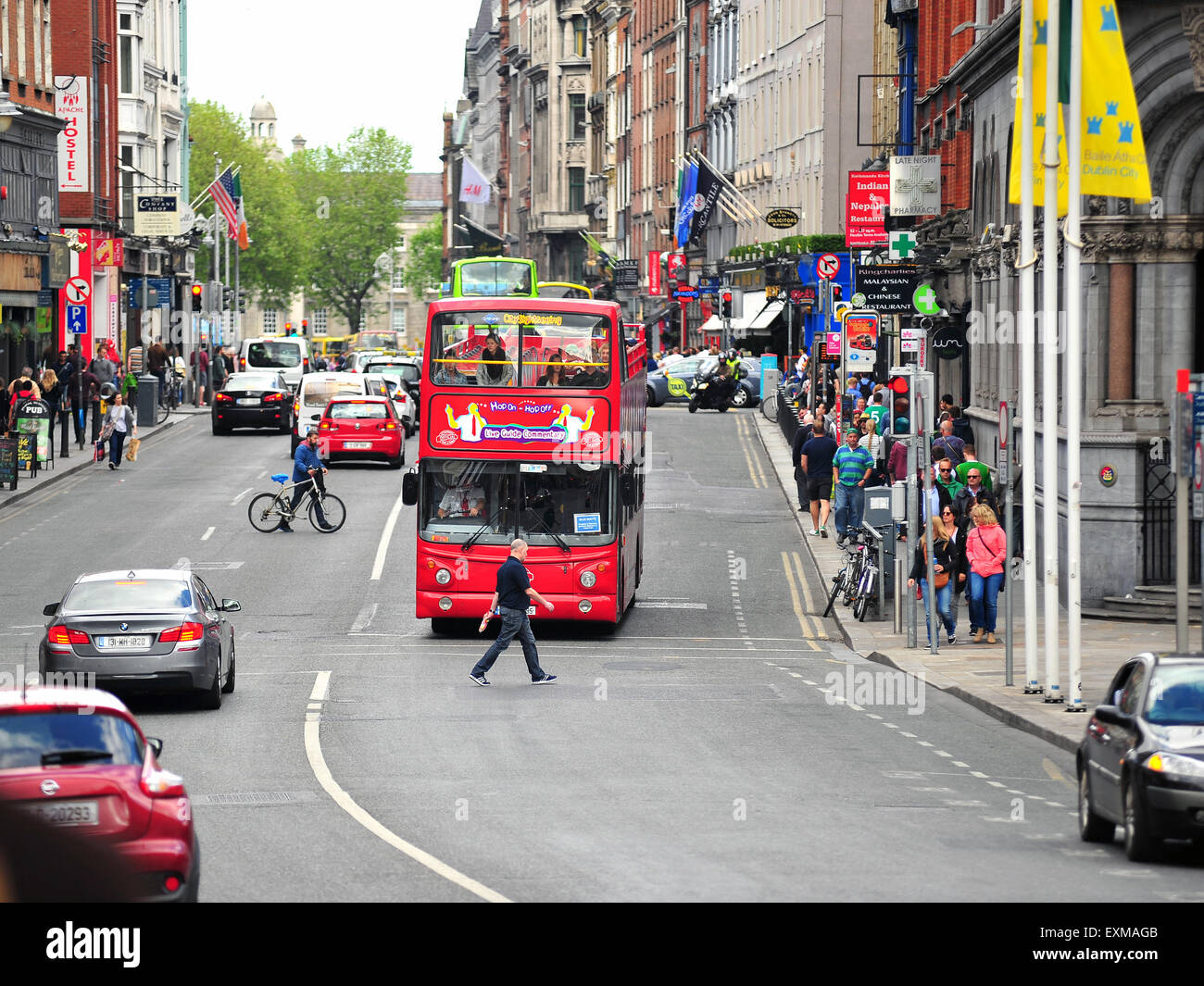 A double decked red tourist bus in the centre of Dublin in Ireland ...