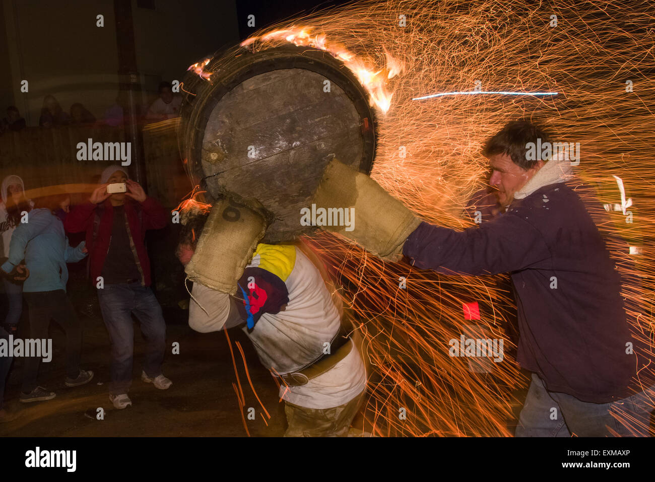 Burning barrel sending out a shower of sparks whilst being carried down ...