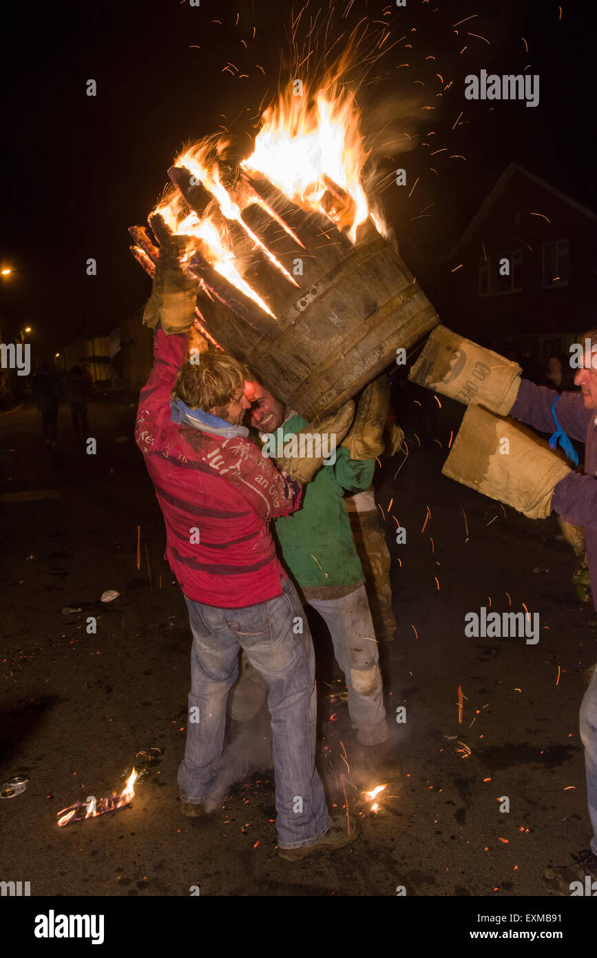 Man hoisting a collapsing burning barrel onto his shoulders on Yonder ...