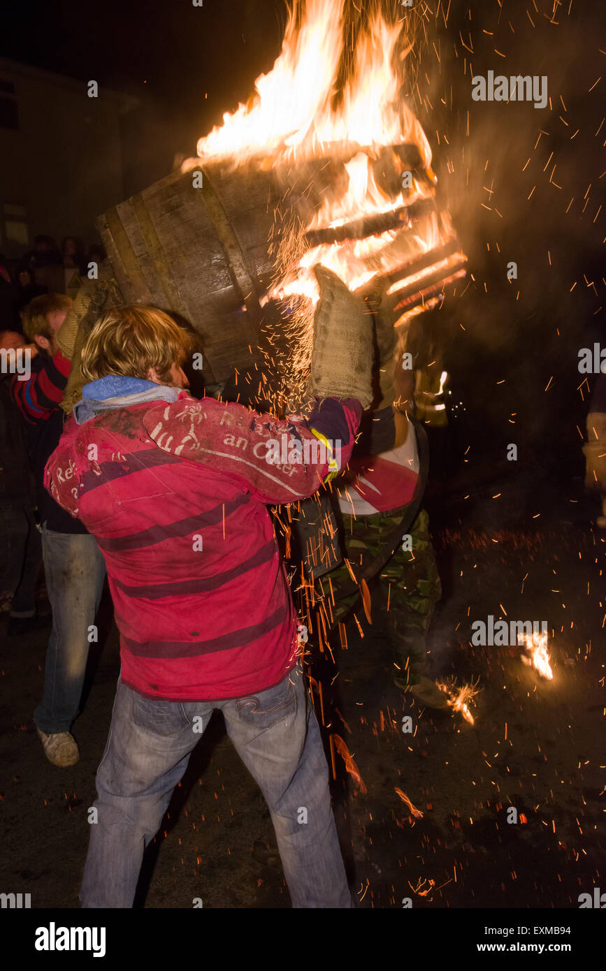 Man hoisting a collapsing burning barrel onto his shoulders on Yonder ...