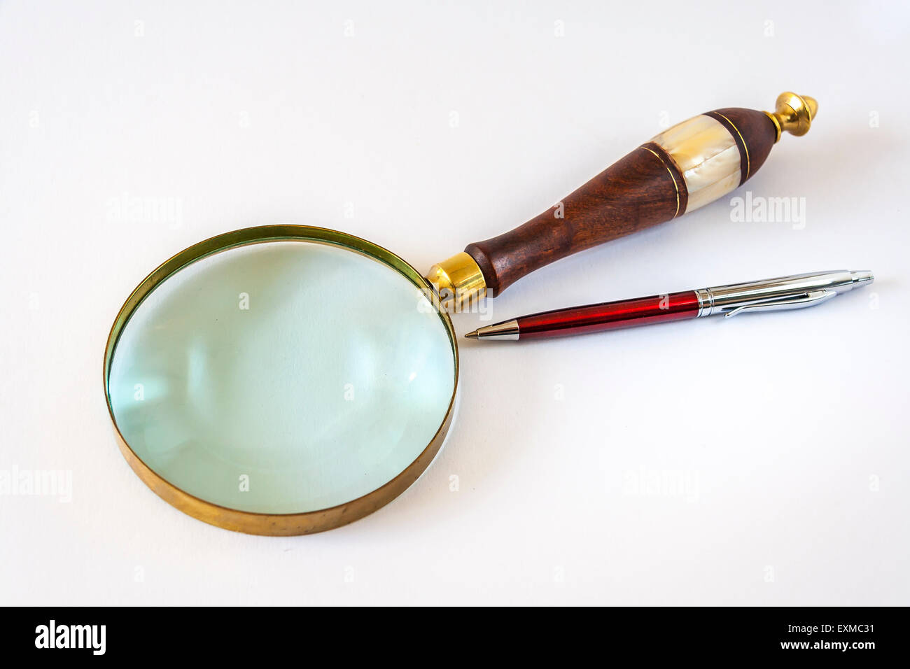 Magnifying Glass And Ballpoint Pen On White Background Stock Photo - Alamy