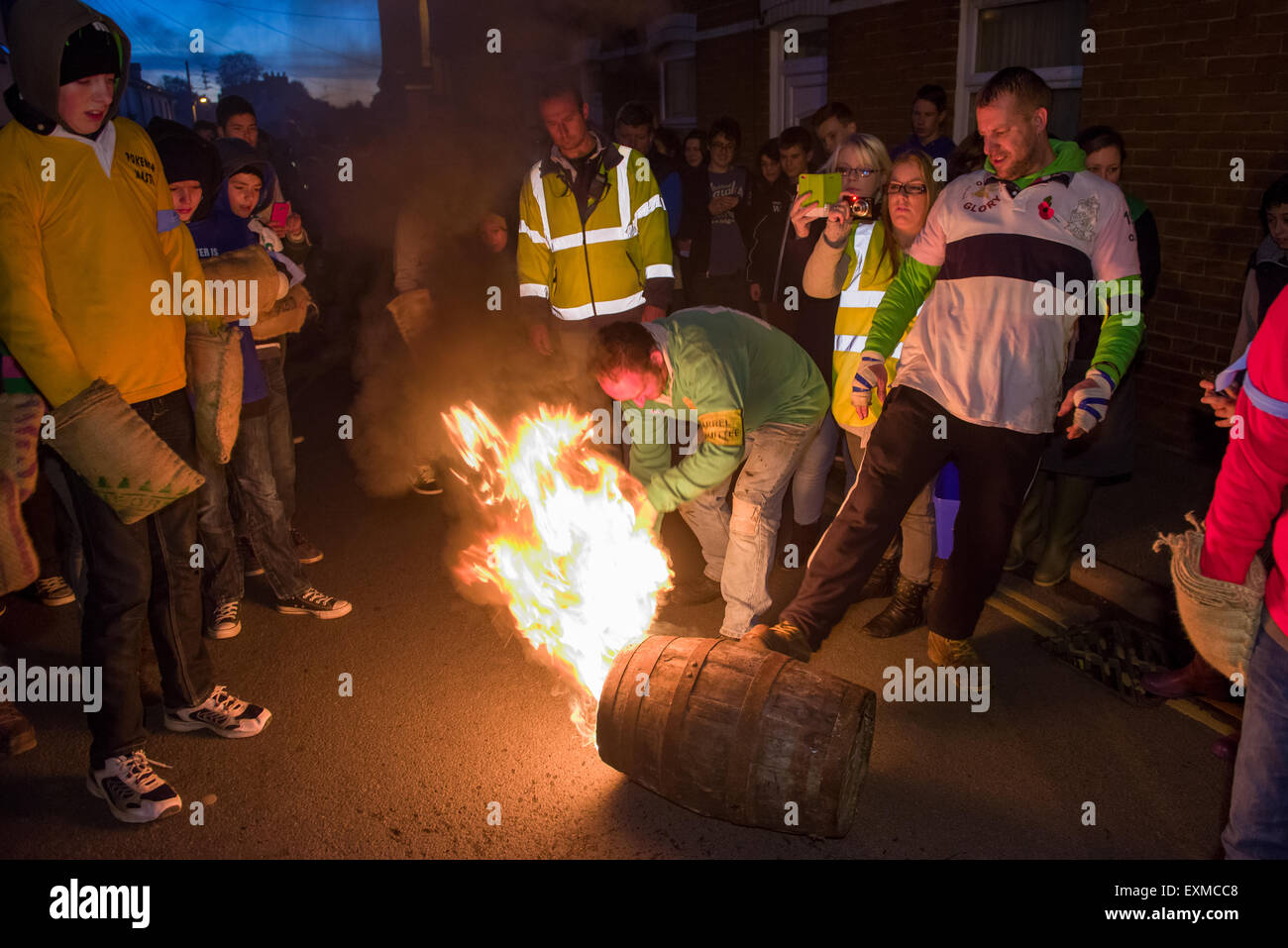 Lighting one of the smaller childrens' barellels to mark Bonfire Night ...