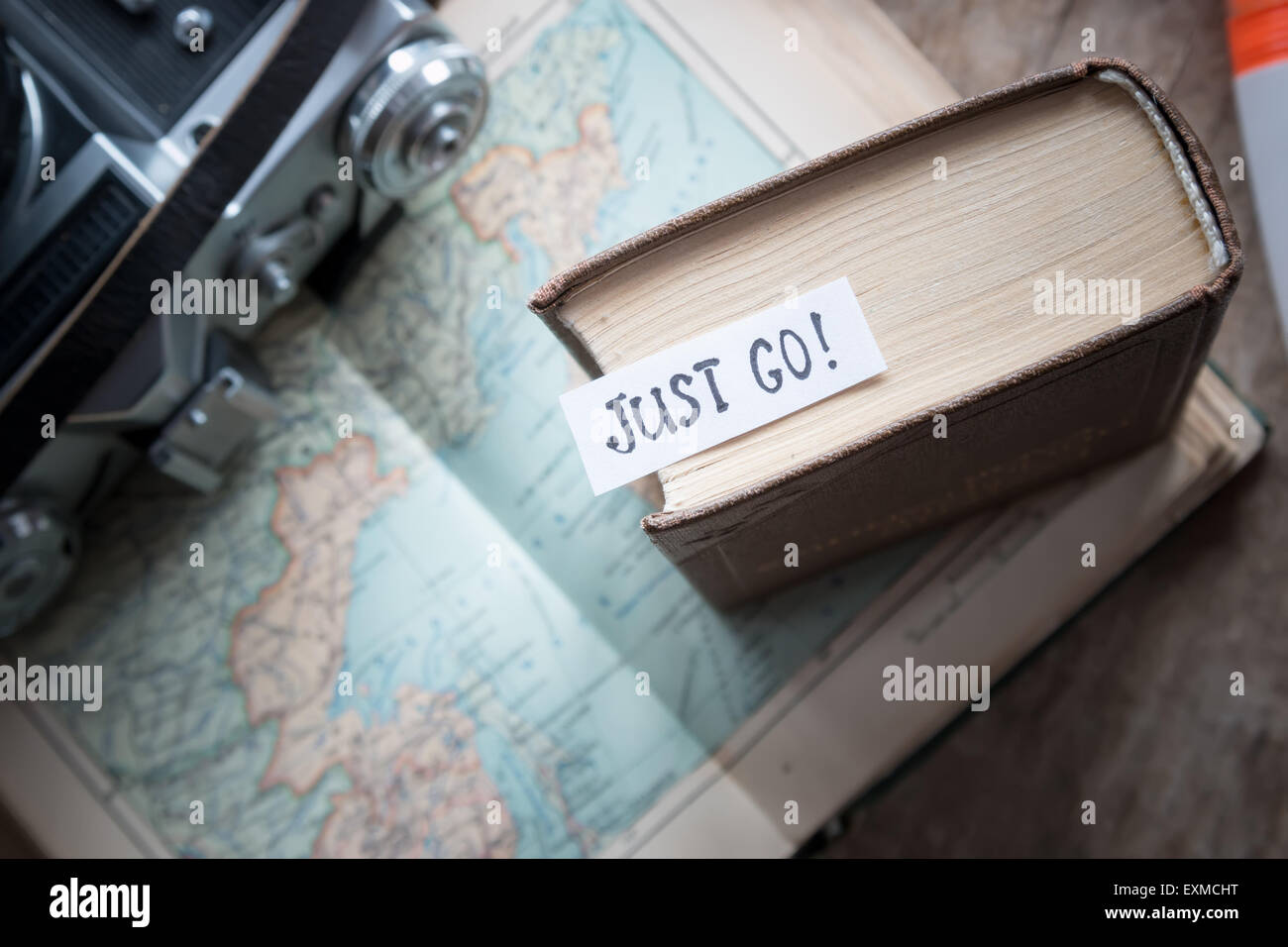 Text "Just go" book and map. Travel and tourism concept. Vintage photo ...