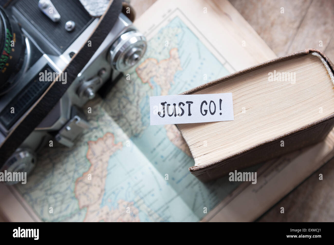 text "Just go" book, map and retro camera. Travel and tourism concept ...