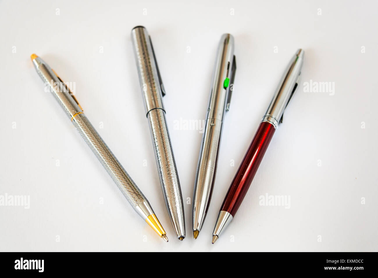 Four Pens On White Background Stock Photo - Alamy