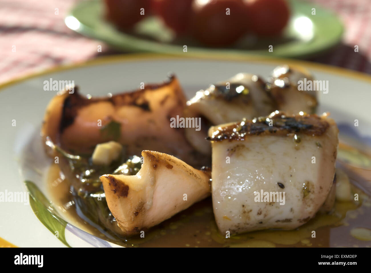 squids at the griddle with seasoning of oil and lemon Stock Photo - Alamy