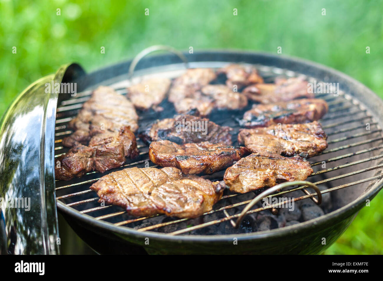Grilling pork meat with barbecue stuff. Horizontal close up shot Stock ...