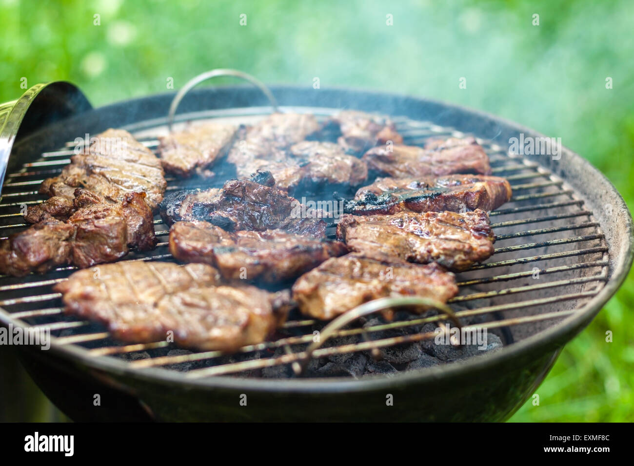 Grilling pork meat with barbecue stuff. Horizontal close up shot Stock ...