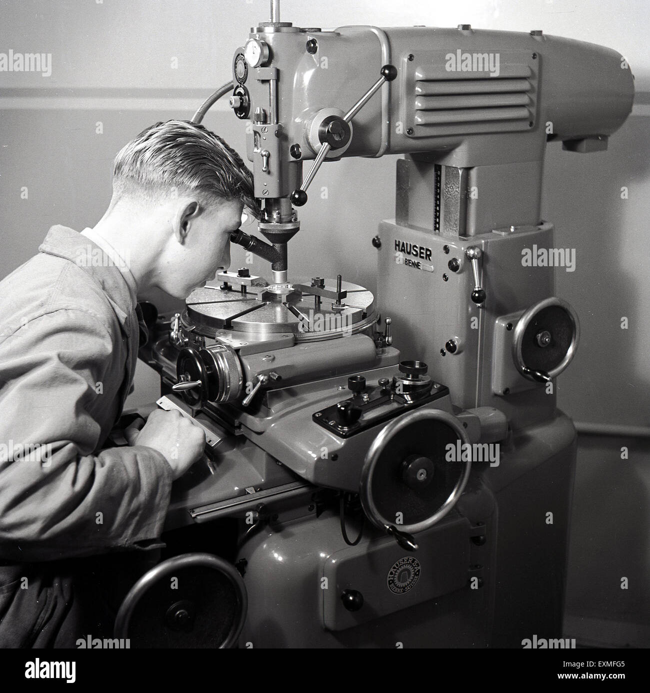 1950s, historical picture showing a young male apprentice using a ...