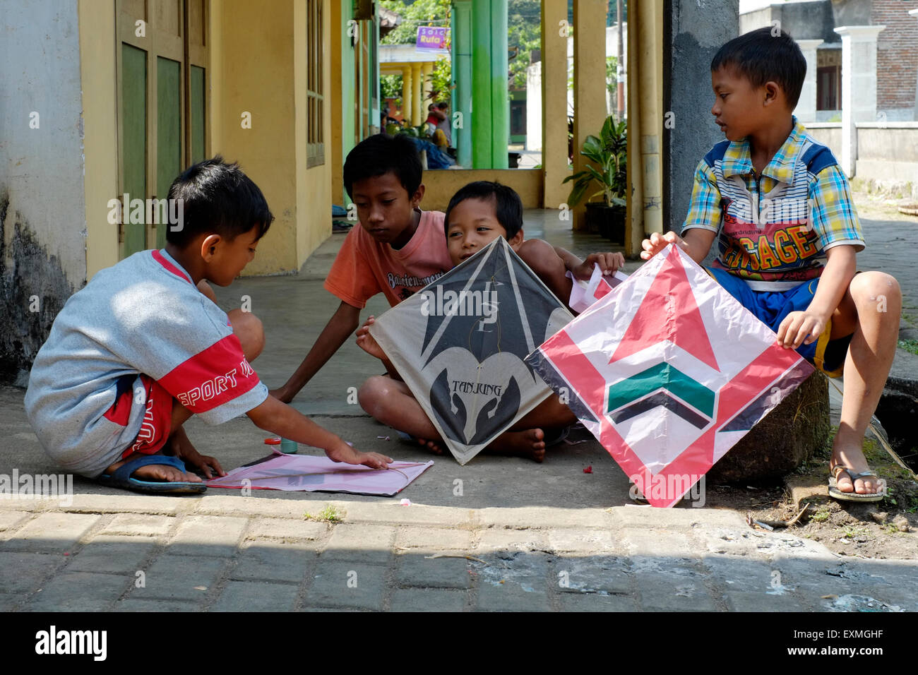 young local village boys making kites by hand near malang java ...