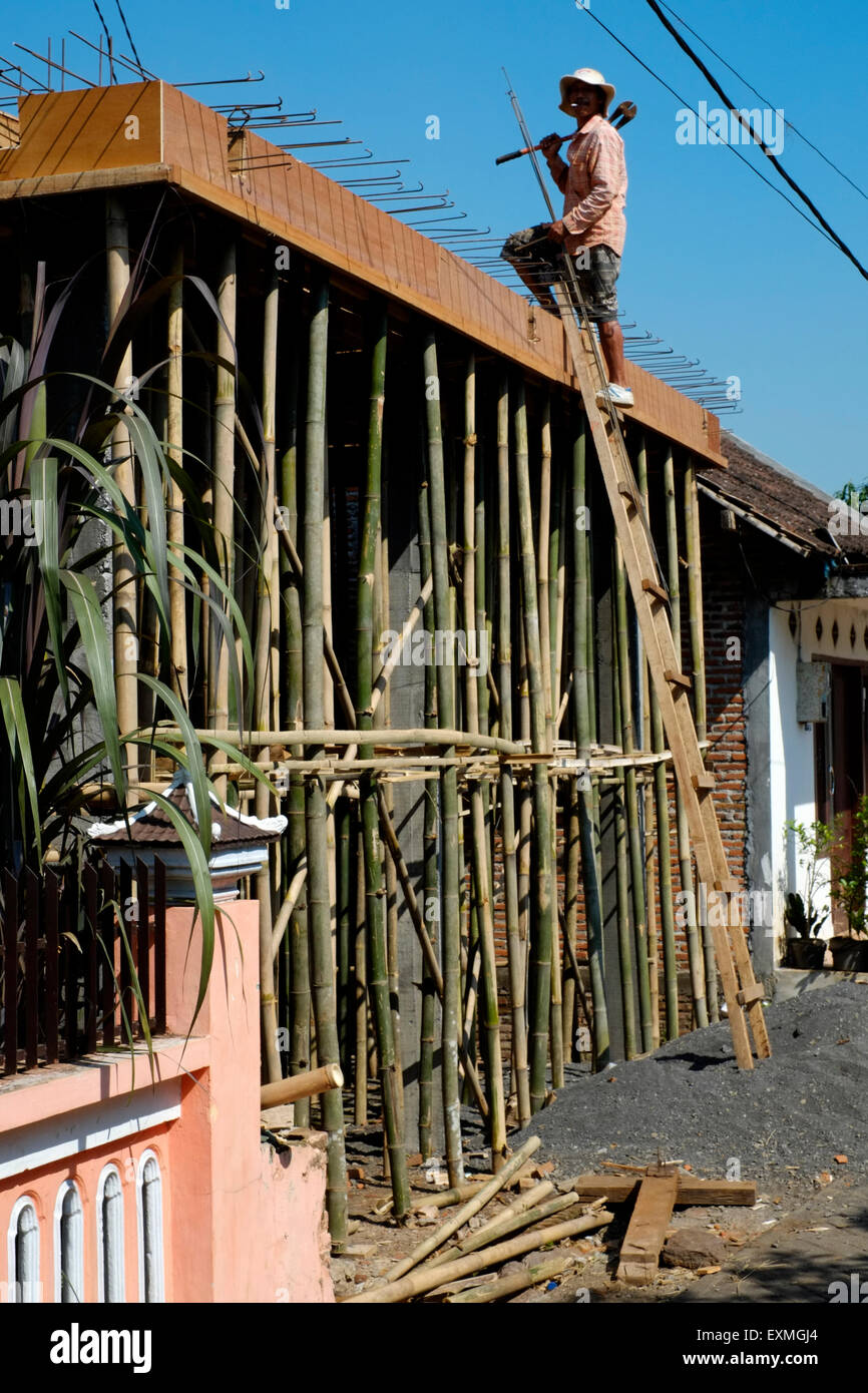 local villagers combine forces to work on the construction of a new ...