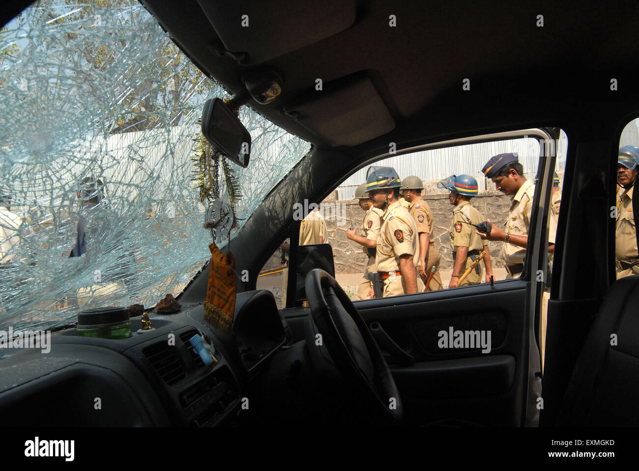 Police personnel patrolling when rioters break glass panes vehicles ...