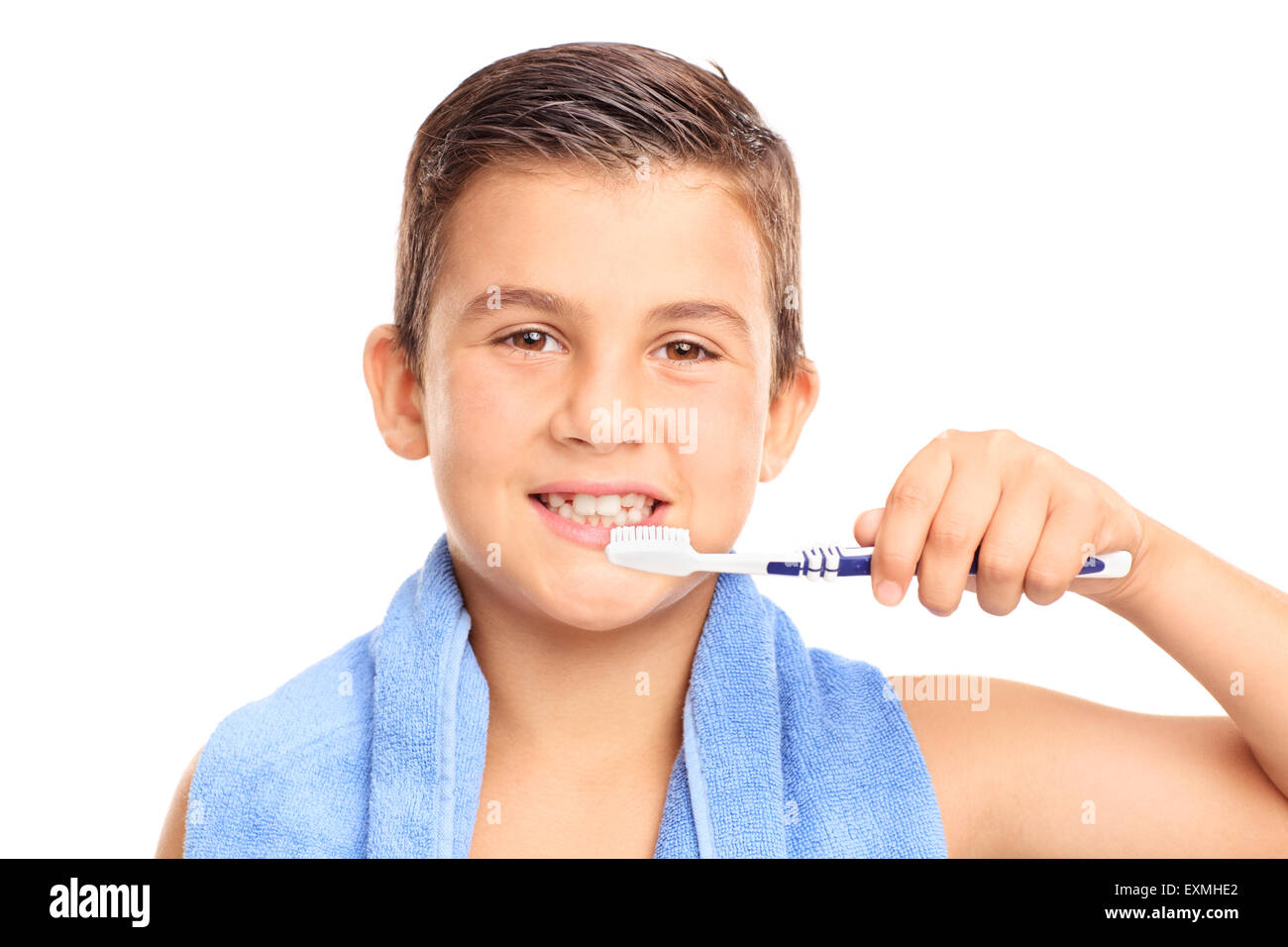 Little boy brushing his teeth with a toothbrush and looking at the ...