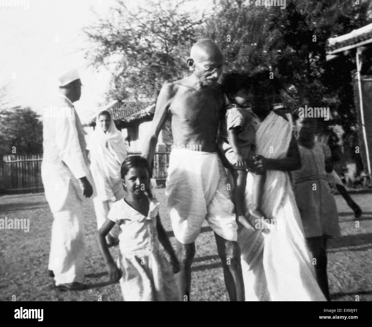 Mahatma Gandhi Walking With His Grand Daughter In Law Saraswati Her Son Shanti And Others At
