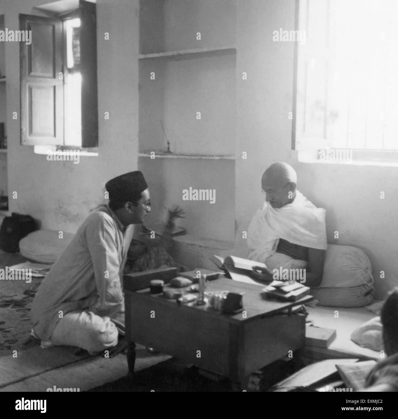 Mahatma Gandhi reading and talking with B K Birla at Bhangi Colony in ...