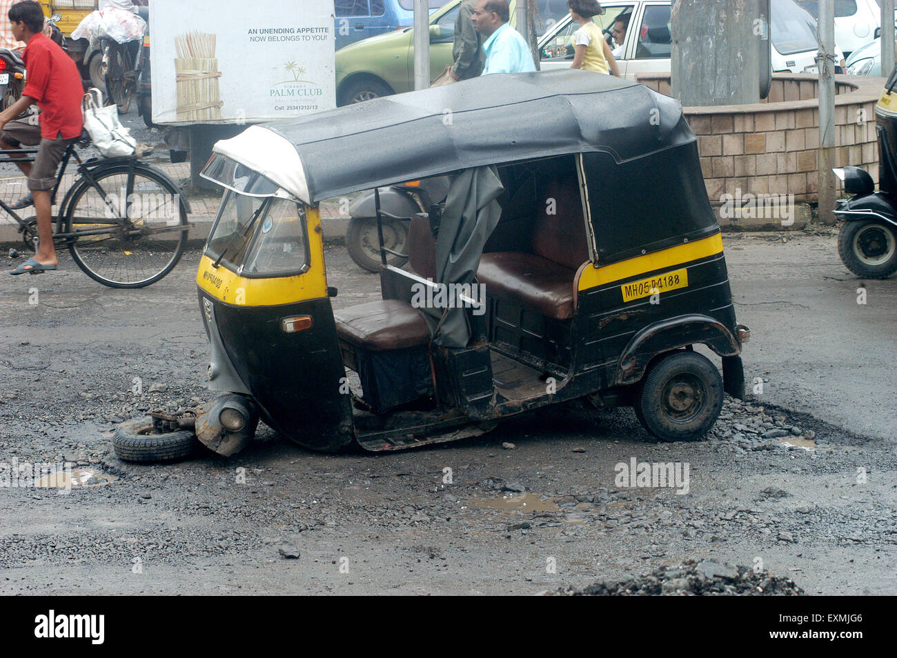Auto rickshaw damaged on broken road ; Thane ; Bombay ; Mumbai ...