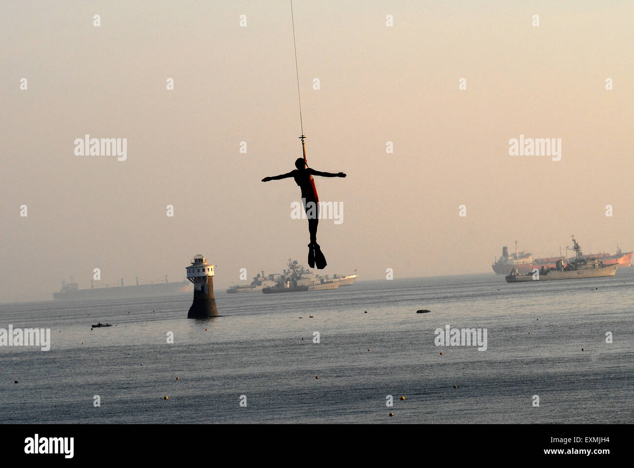Man hanging by rope ; rescue by Indian Navy ; Gateway of India ; Apollo ...