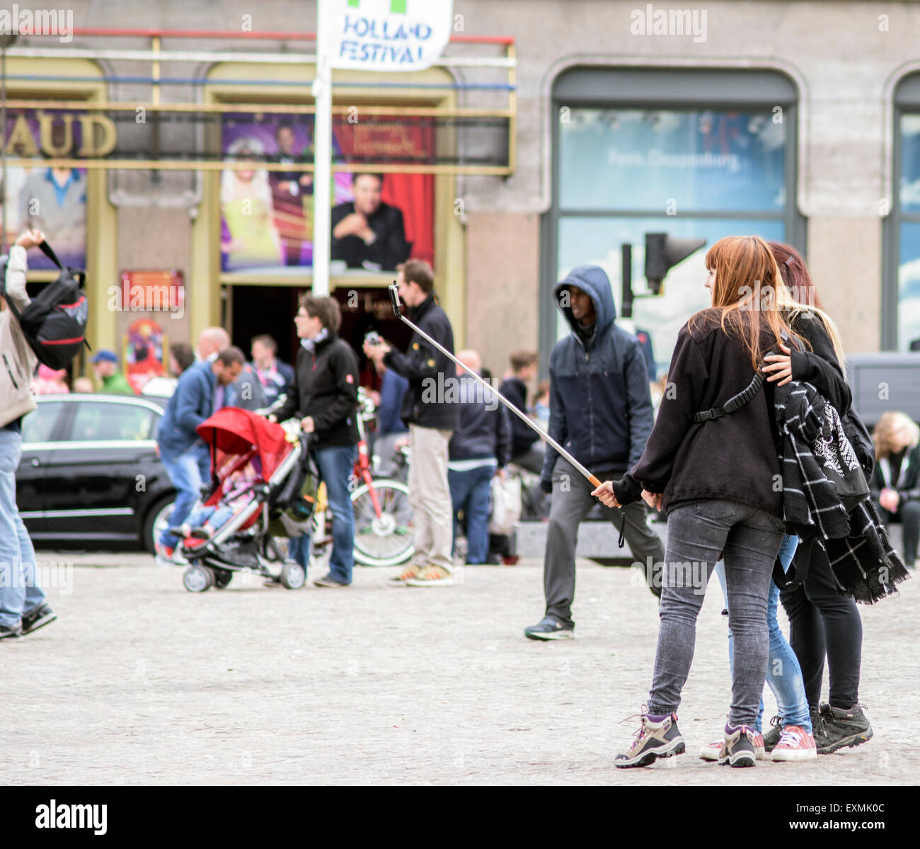 Random tourists near or on Dam Square and the Royal Palace in the city ...