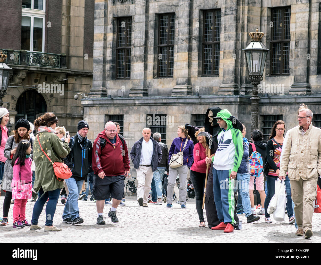 Random tourists near or on Dam Square and the Royal Palace in the city ...