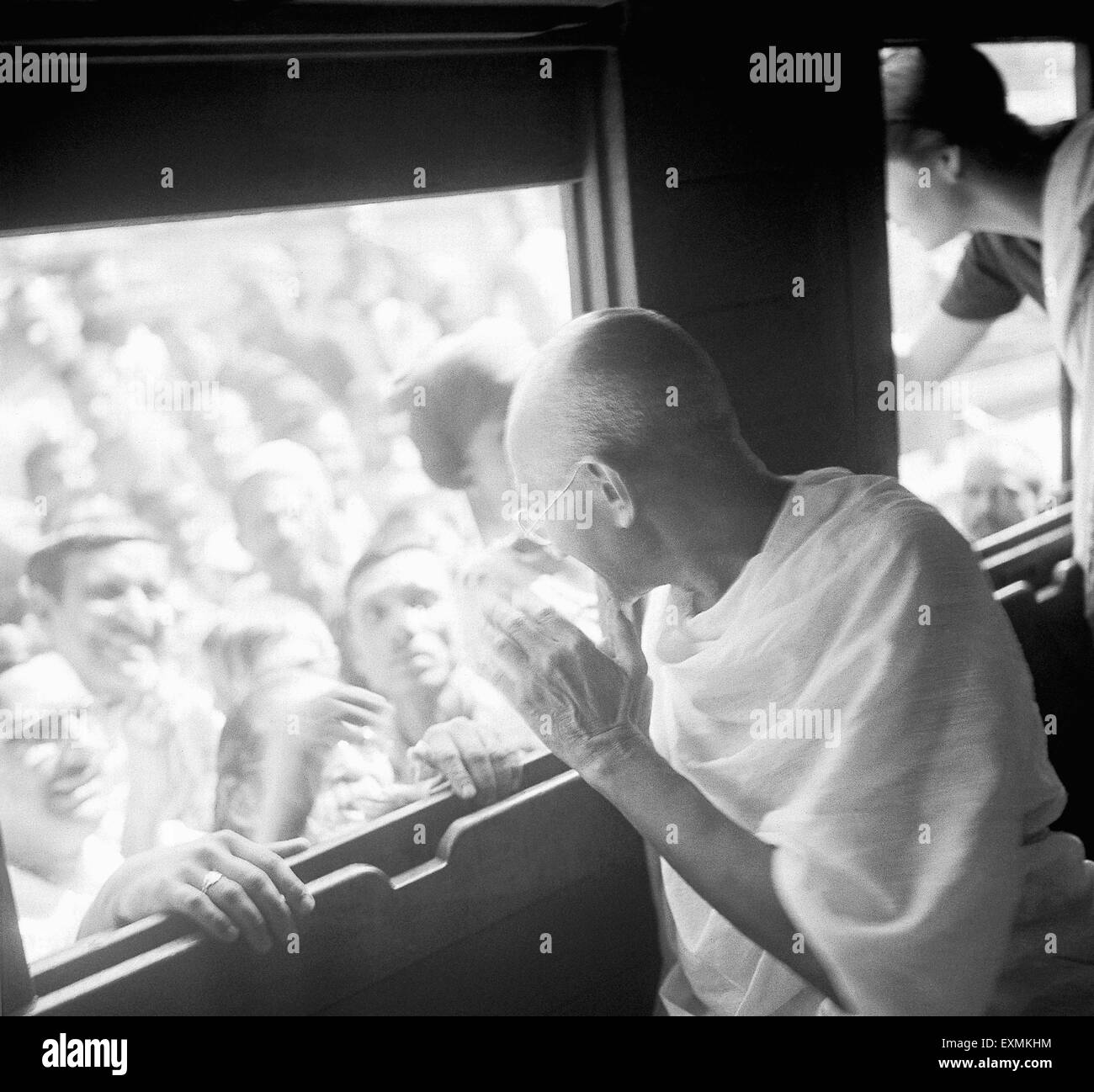 Mahatma Gandhi ; sitting in a train and interacting with people ...