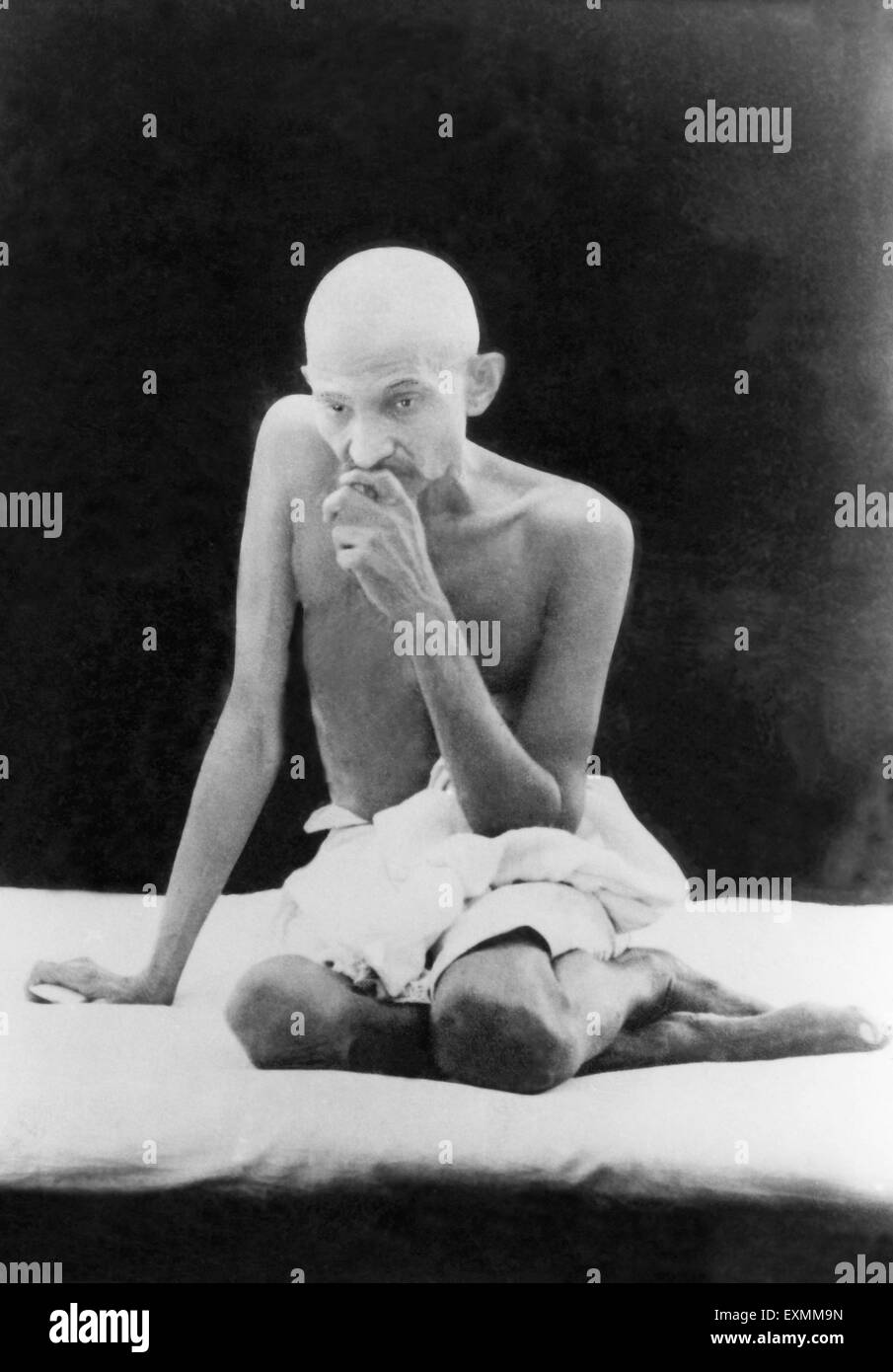 Mahatma Gandhi ; with shaved head in characteristic pose ; India NO MR ...