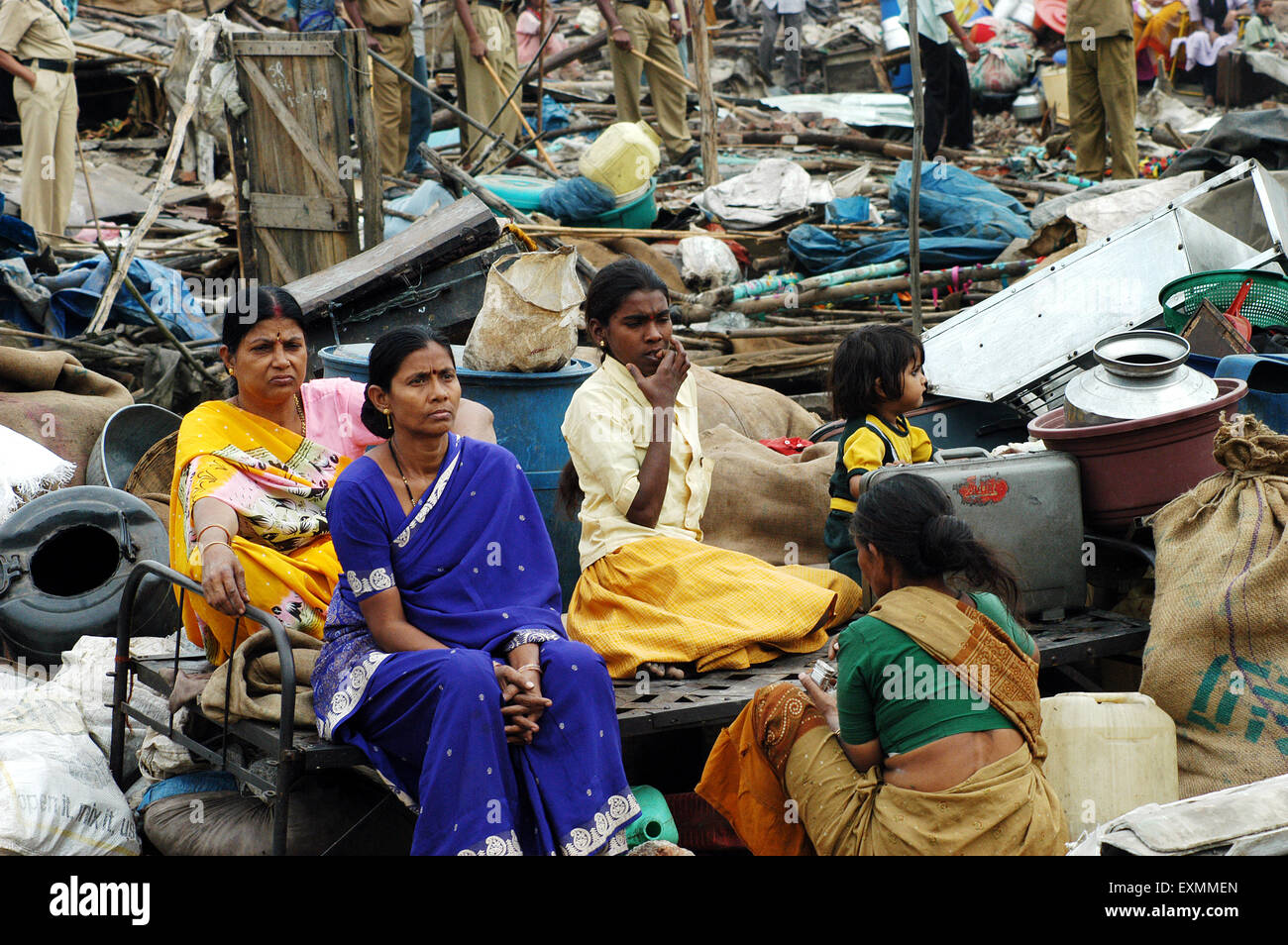 Slum dwellers sit with their belongings after the demolition of illegal ...