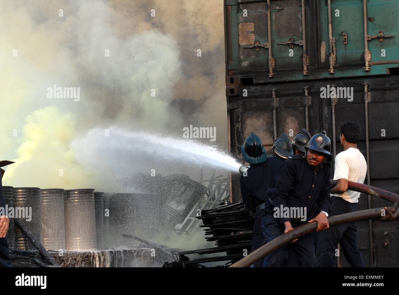 Fire brigade personnel or fire fighters trying to extinguish fire in ...
