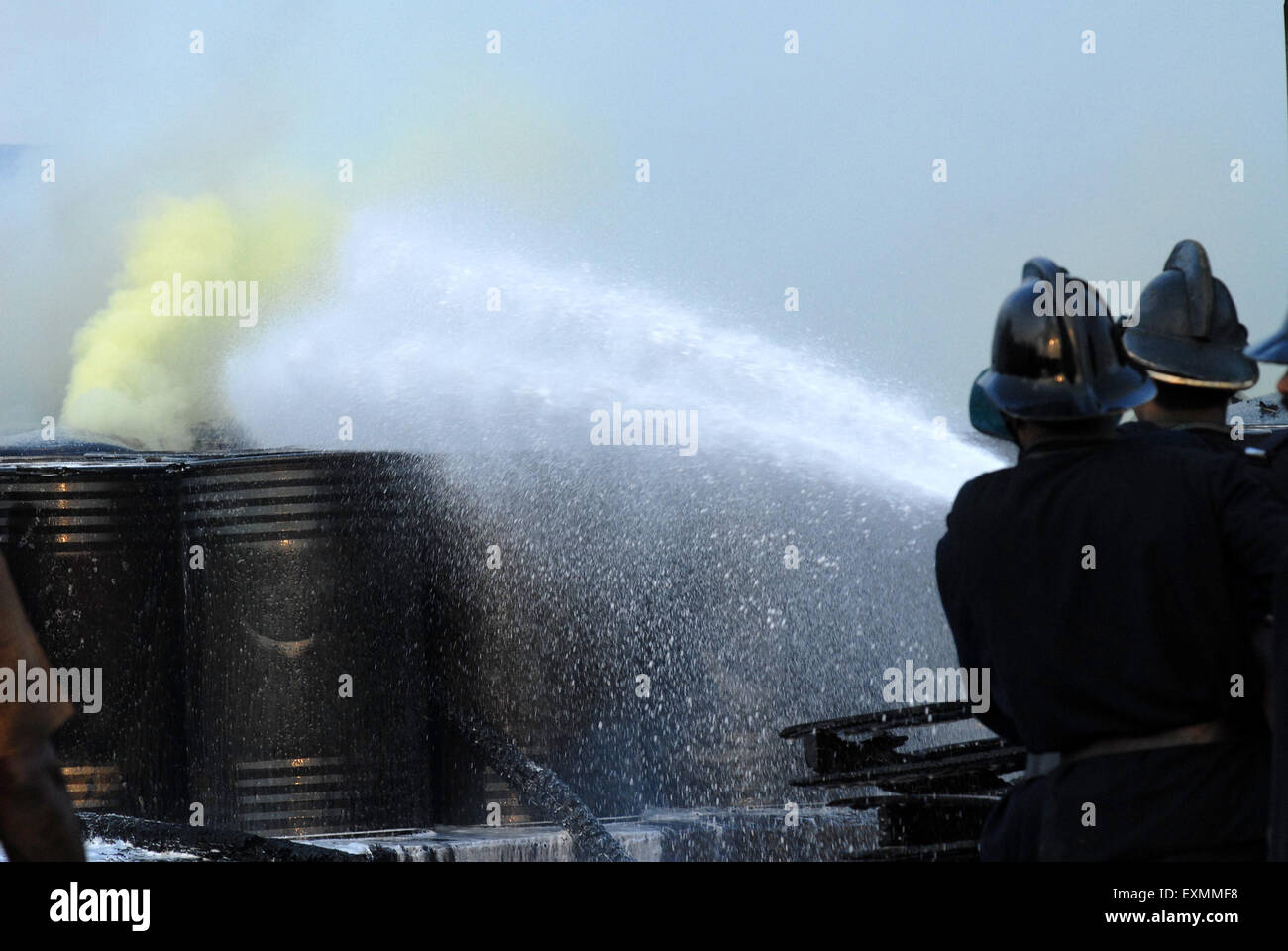 Fire brigade personnel or fire fighters trying to extinguish fire in ...