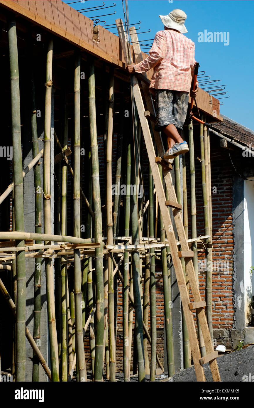 local villagers combine forces to work on the construction of a new ...