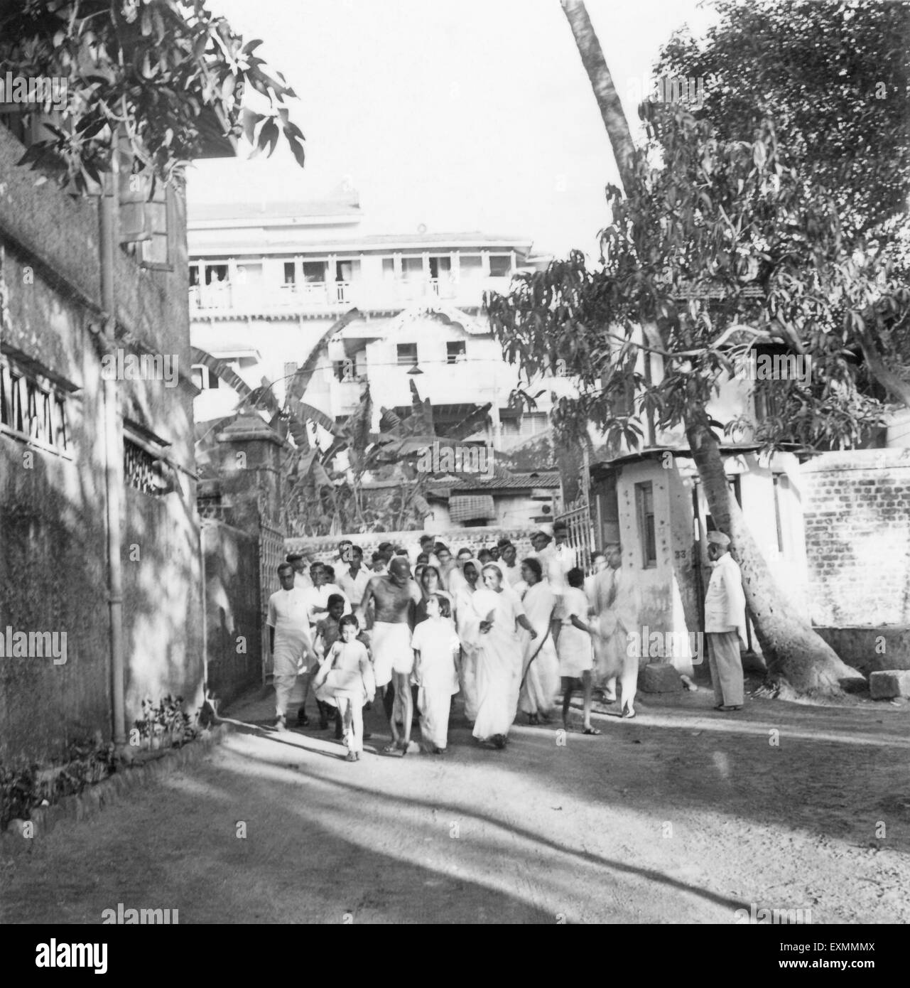Mahatma Gandhi and others walking on the compound of Birla House after ...