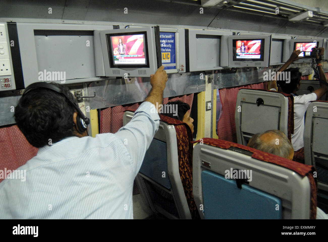 Passenger watching television introduce by Indian Railways on ...