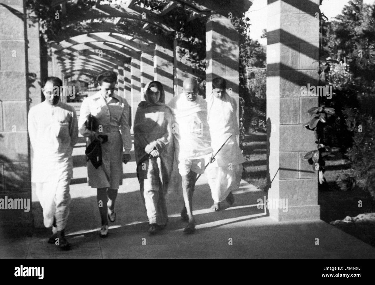 Mahatma Gandhi walking with Pyarelal Nayar and his son Devdas Stock ...