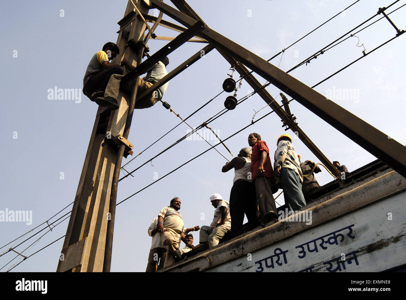 Workers repairing overhead wires of Railway line, Bombay, Mumbai ...