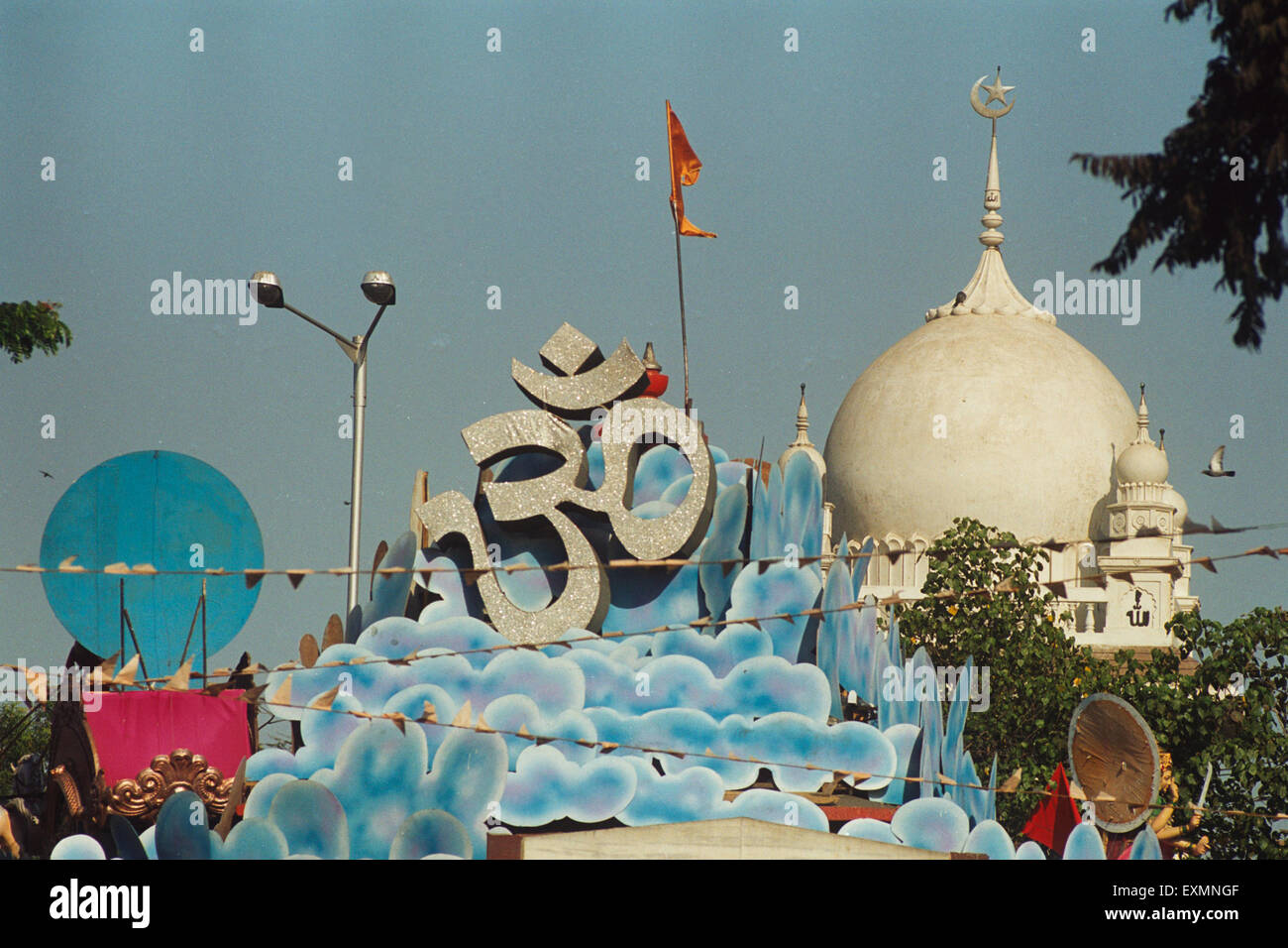 Om Hindu symbol and mosque in background Stock Photo - Alamy