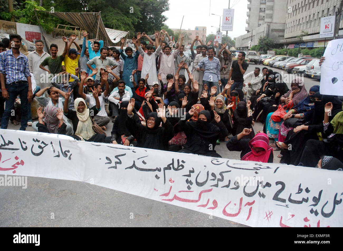 Members of All Workers of Textile Mills chant slogans against non ...