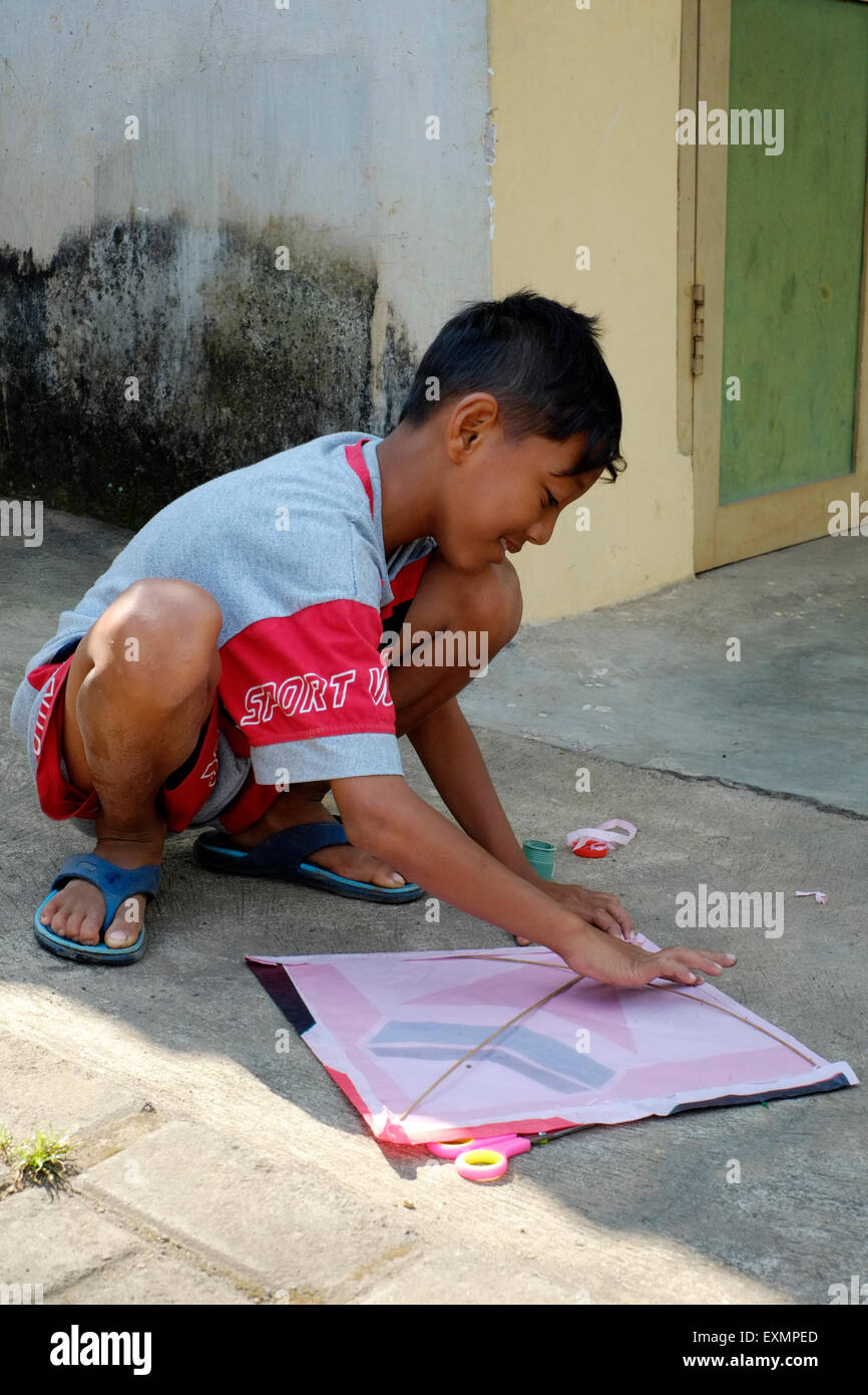 young local village boy making kite by hand near malang java indonesia ...