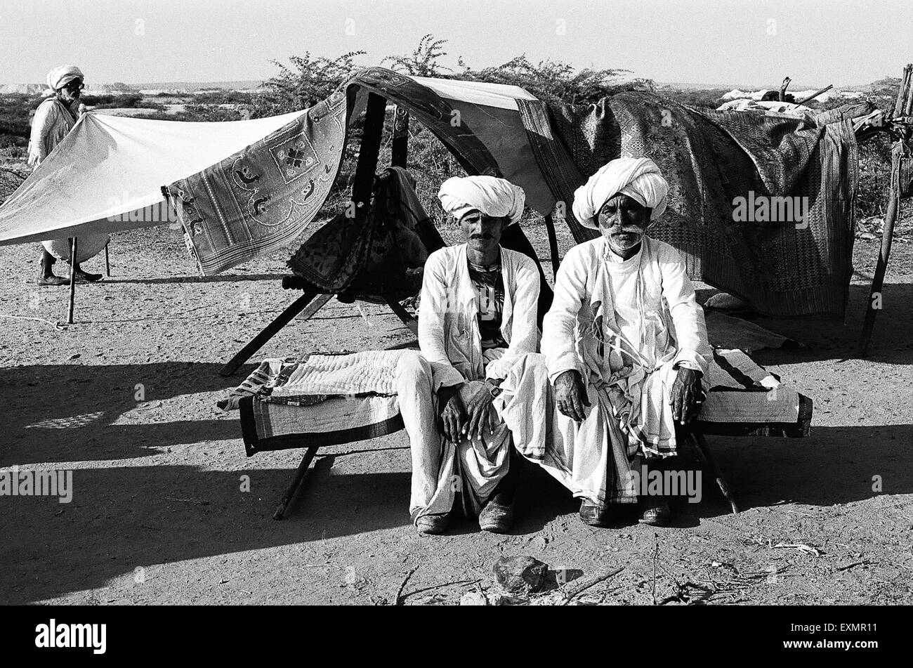 two Rabaris men sitting on charpoy thunda wadh kutch Gujarat India ...
