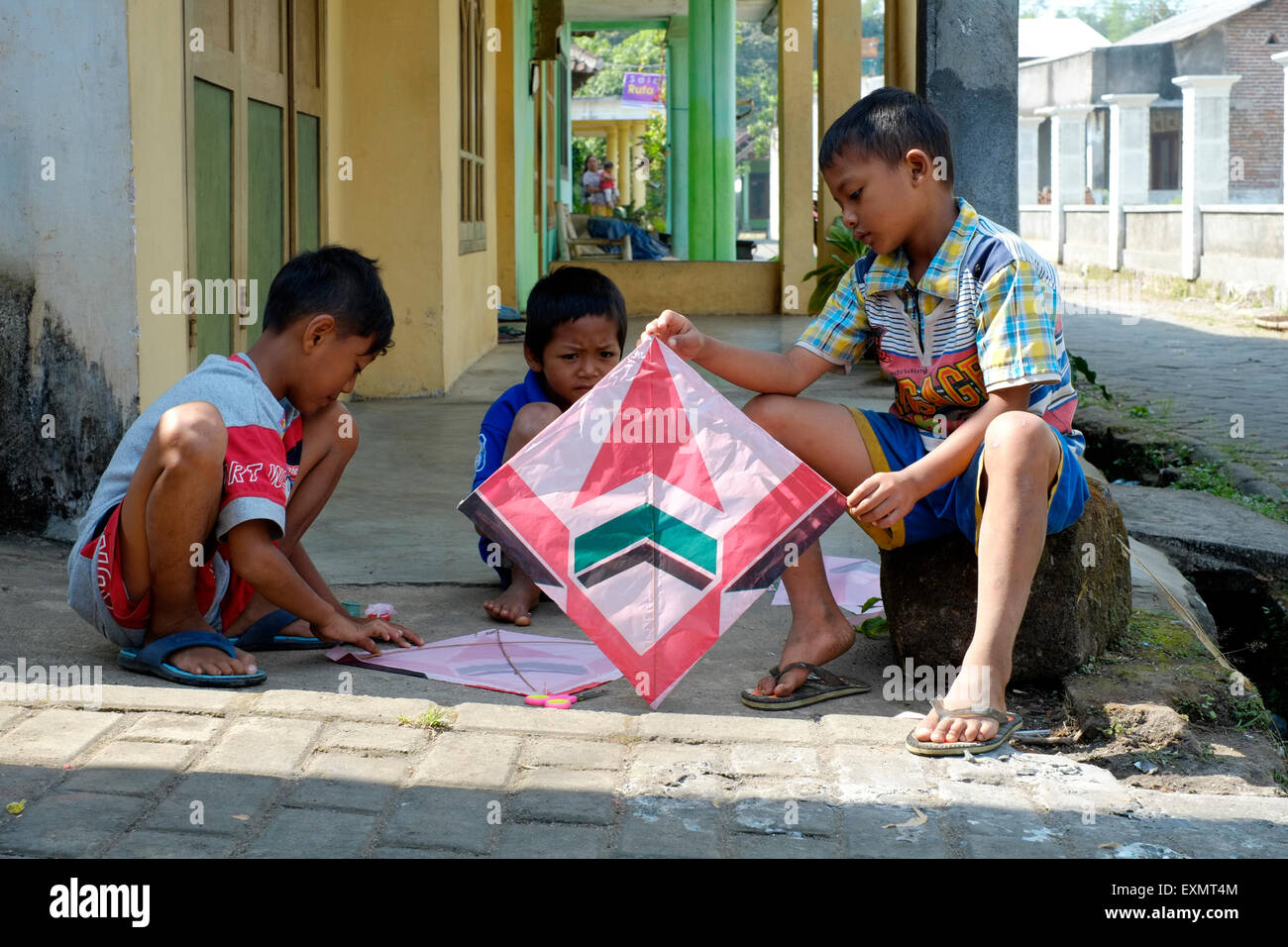 young local village boys making kites by hand near malang java ...