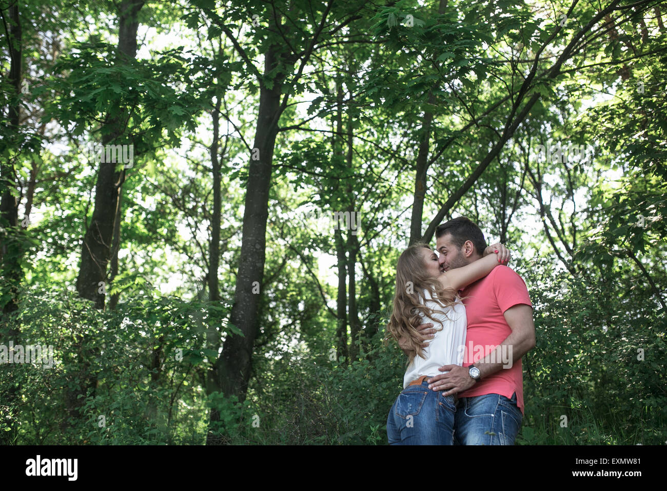 Cute couple in a forest Stock Photo - Alamy