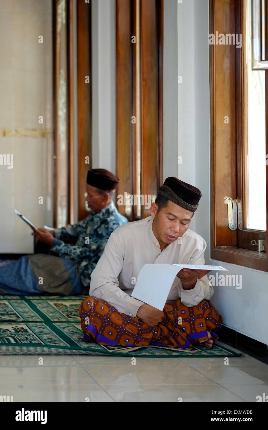 local men read religious scriptures at a small village mosque during ...