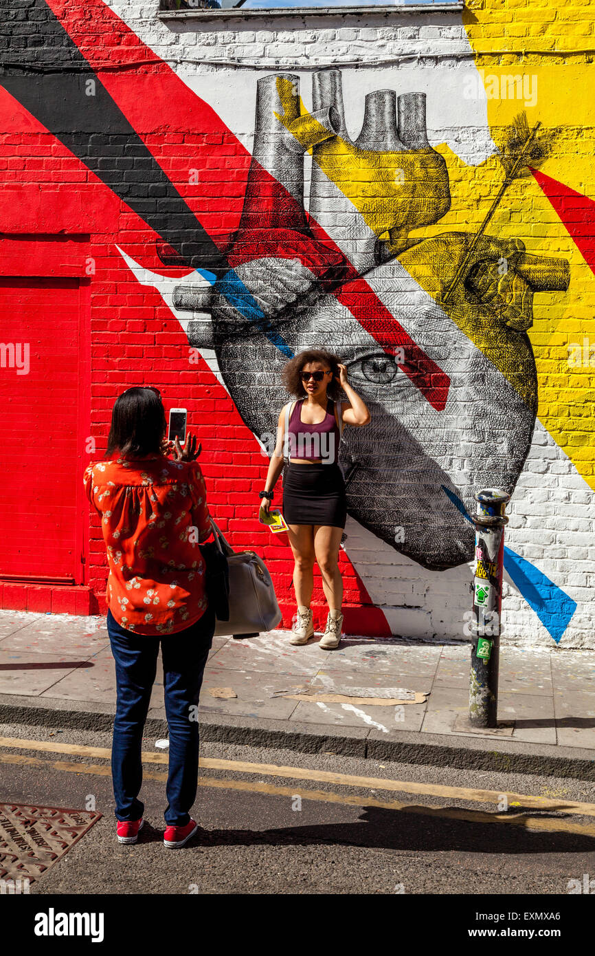 A Young Woman Poses For A Photograph In Front Of Some Street Art ...