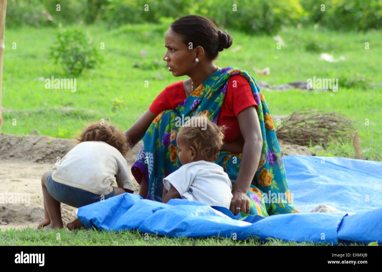 Allahabad, India. 15th July, 2015. An Indian homeless with her child in ...