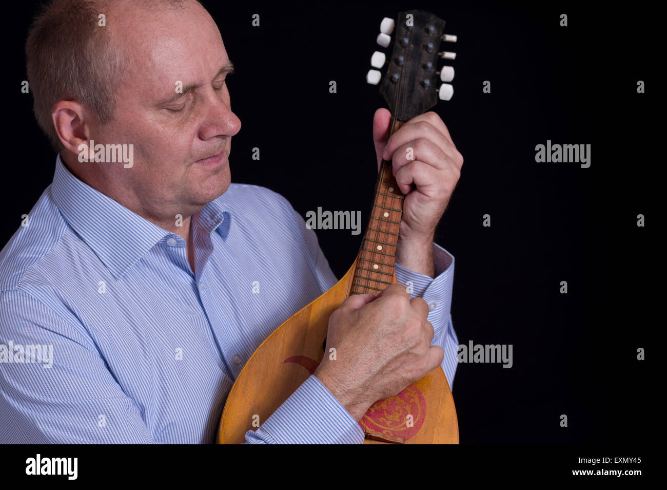 Portrait of mature musician playing with mandolin Stock Photo - Alamy